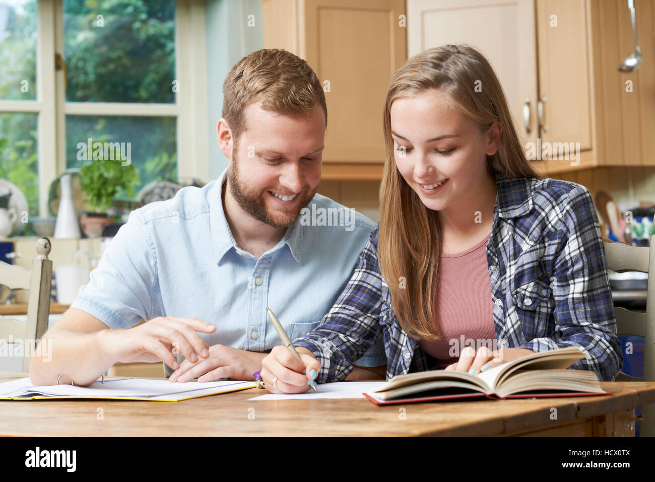 Male Home Tutor Helping Teenage Girl With Studies Stock Photo - Alamy