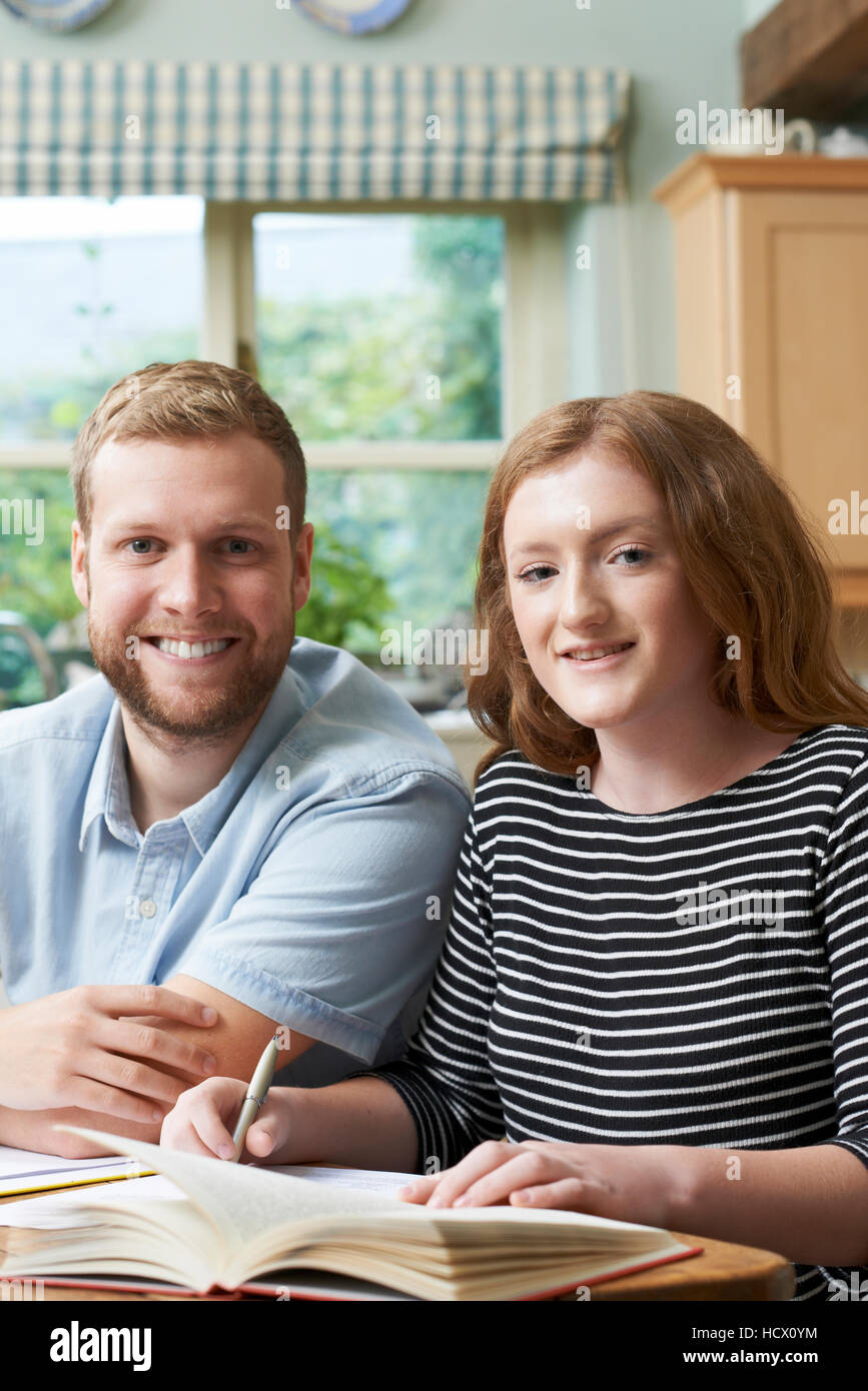 Male Home Tutor Helping Teenage Girl With Studies Stock Photo - Alamy