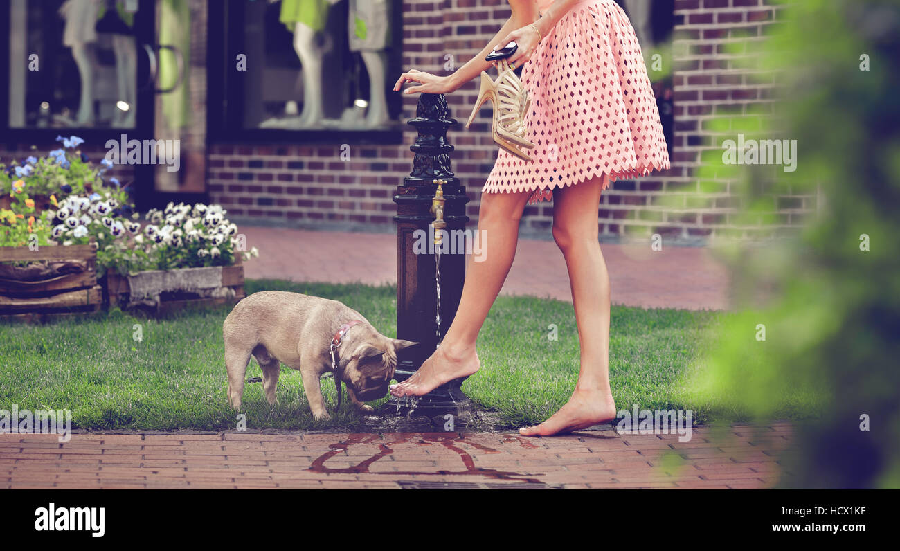 Girl with dog washing legs in the well Stock Photo - Alamy