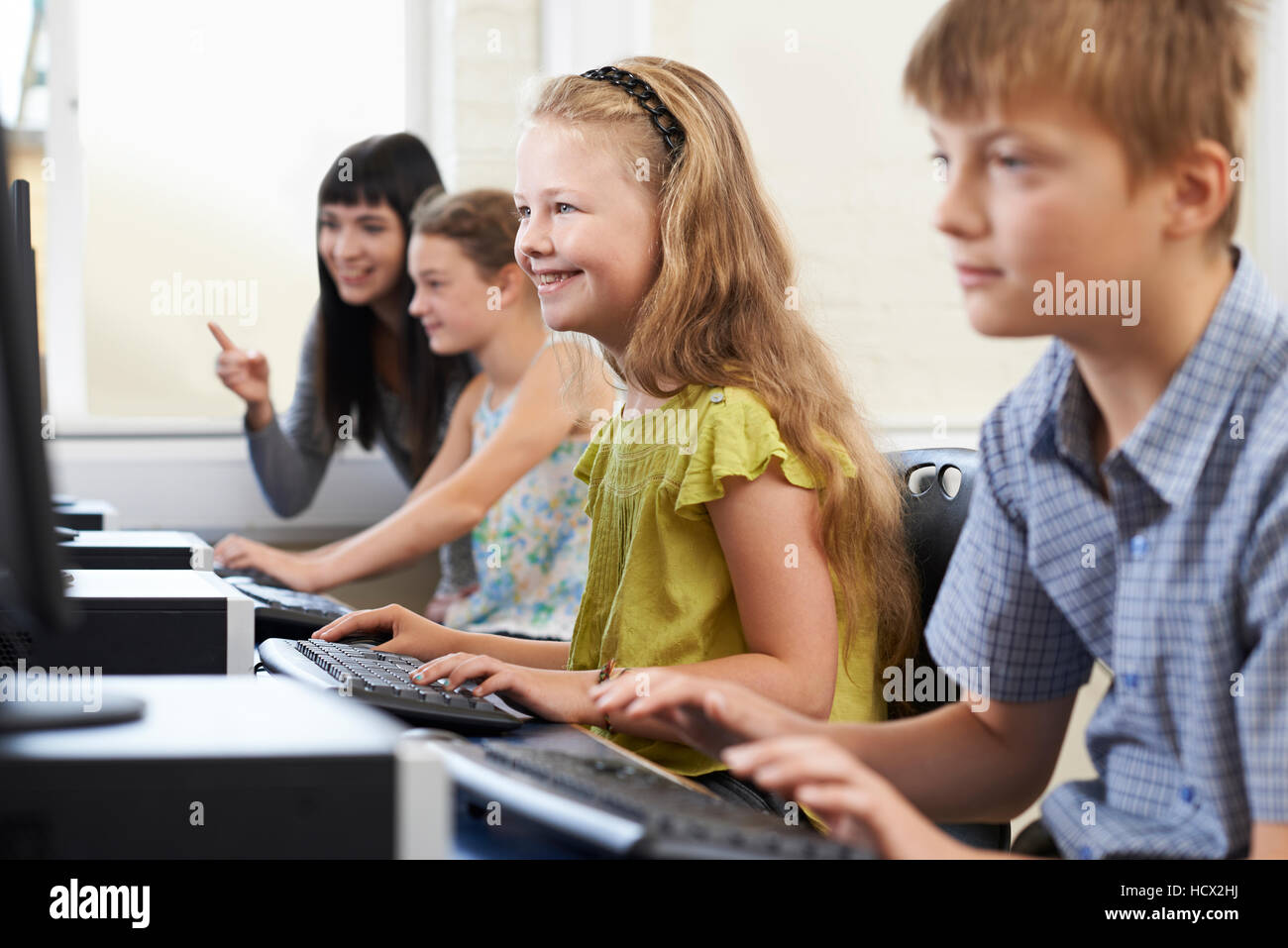 Elementary Pupils In Computer Class With Teacher Stock Photo - Alamy