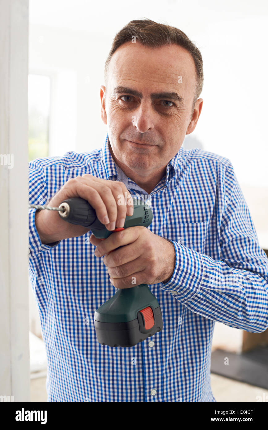 Man Using Electric Drill In House Renovation Project Stock Photo - Alamy