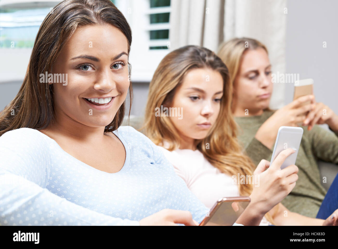 Group Of Teenage Girls Using Mobile Phones At Home Stock Photo - Alamy