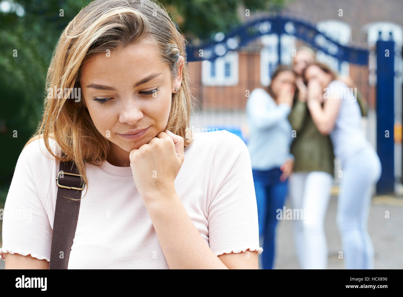 Unhappy Girl Being Gossiped About By School Friends Stock Photo - Alamy