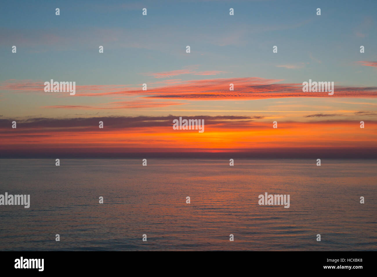 Natural sunset at sea with clouds and horizon Stock Photo - Alamy