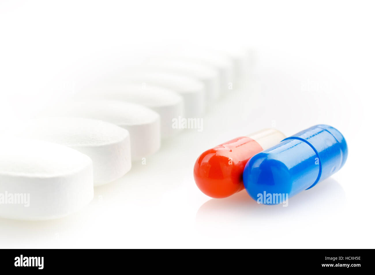 Red, Blue Capsules and White Pills Stock Photo - Alamy