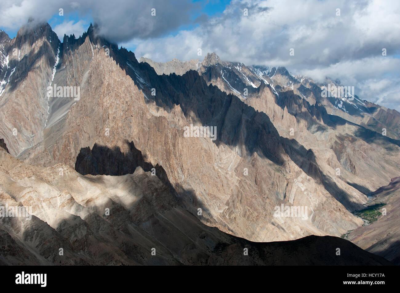 Light and shadow move across the jagged peaks of the Zanskar range seen ...