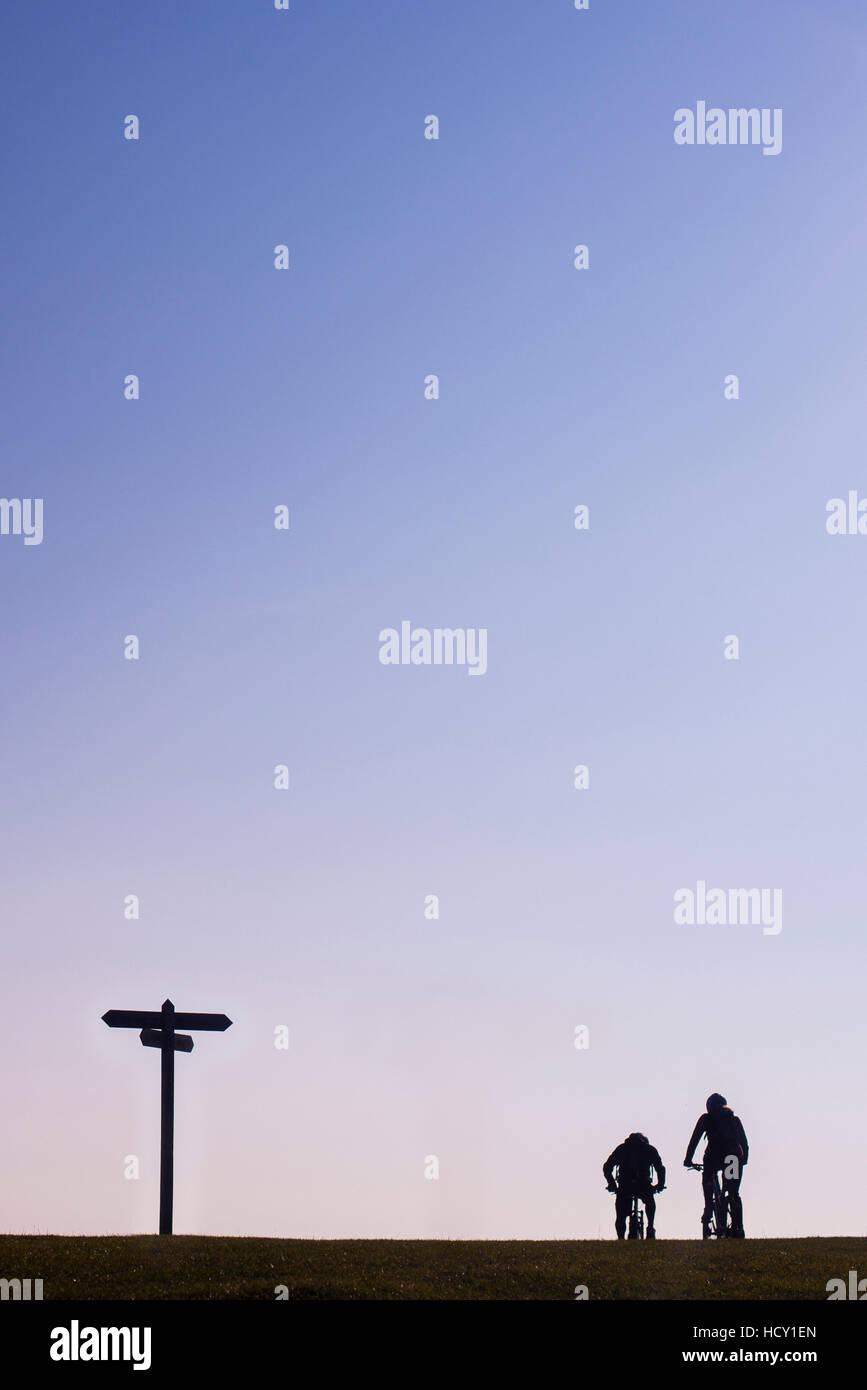 Cycling past a direction sign on the open coastal paths near Old Harry ...