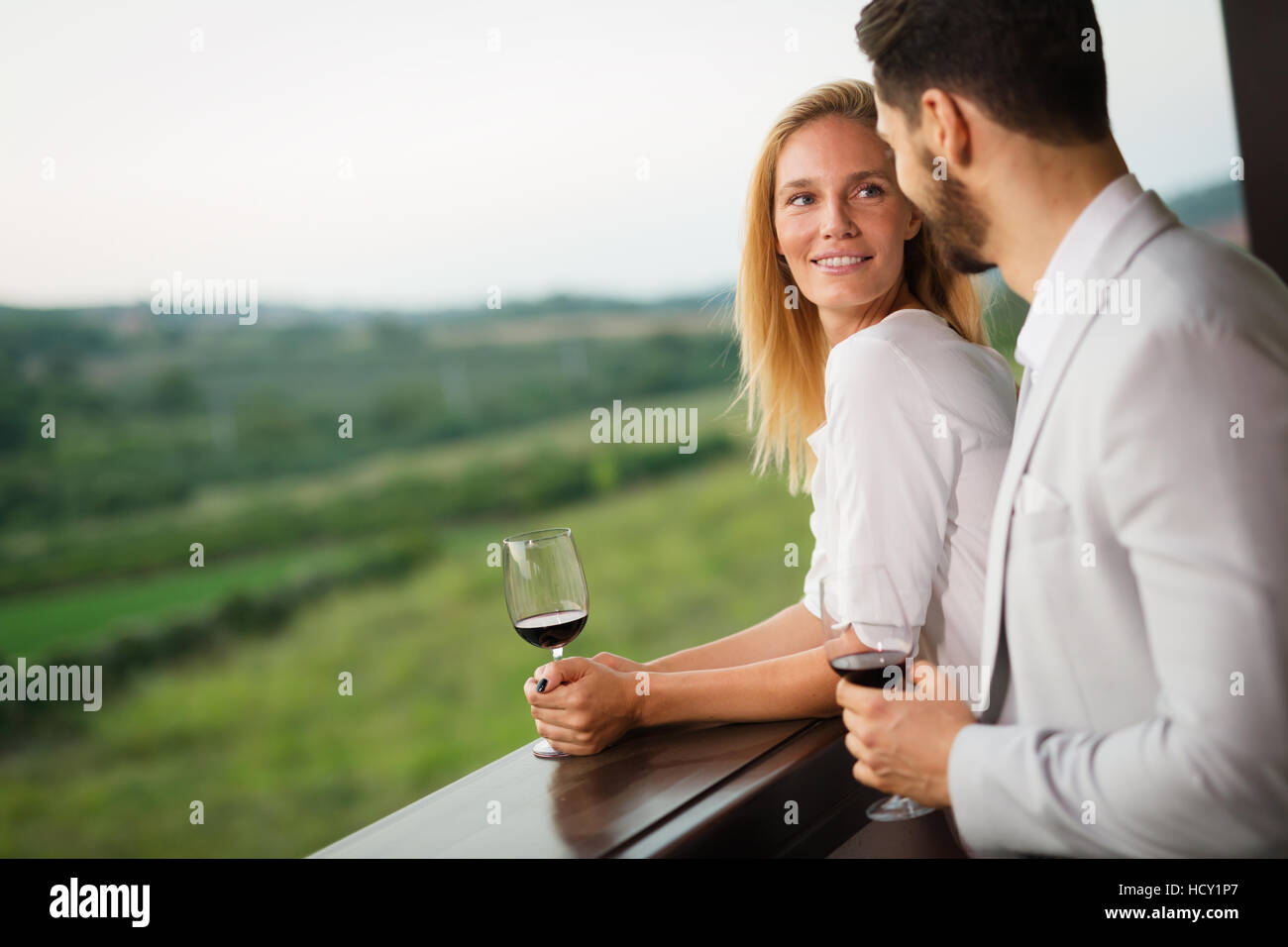 Beautiful romantic couple drinking red wine Stock Photo - Alamy