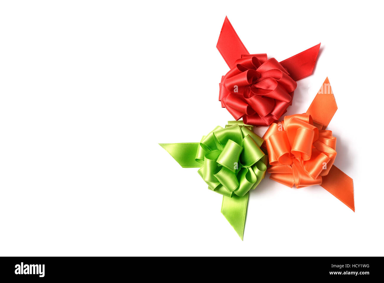 some satin gift ribbon bows of different colors on a white background ...