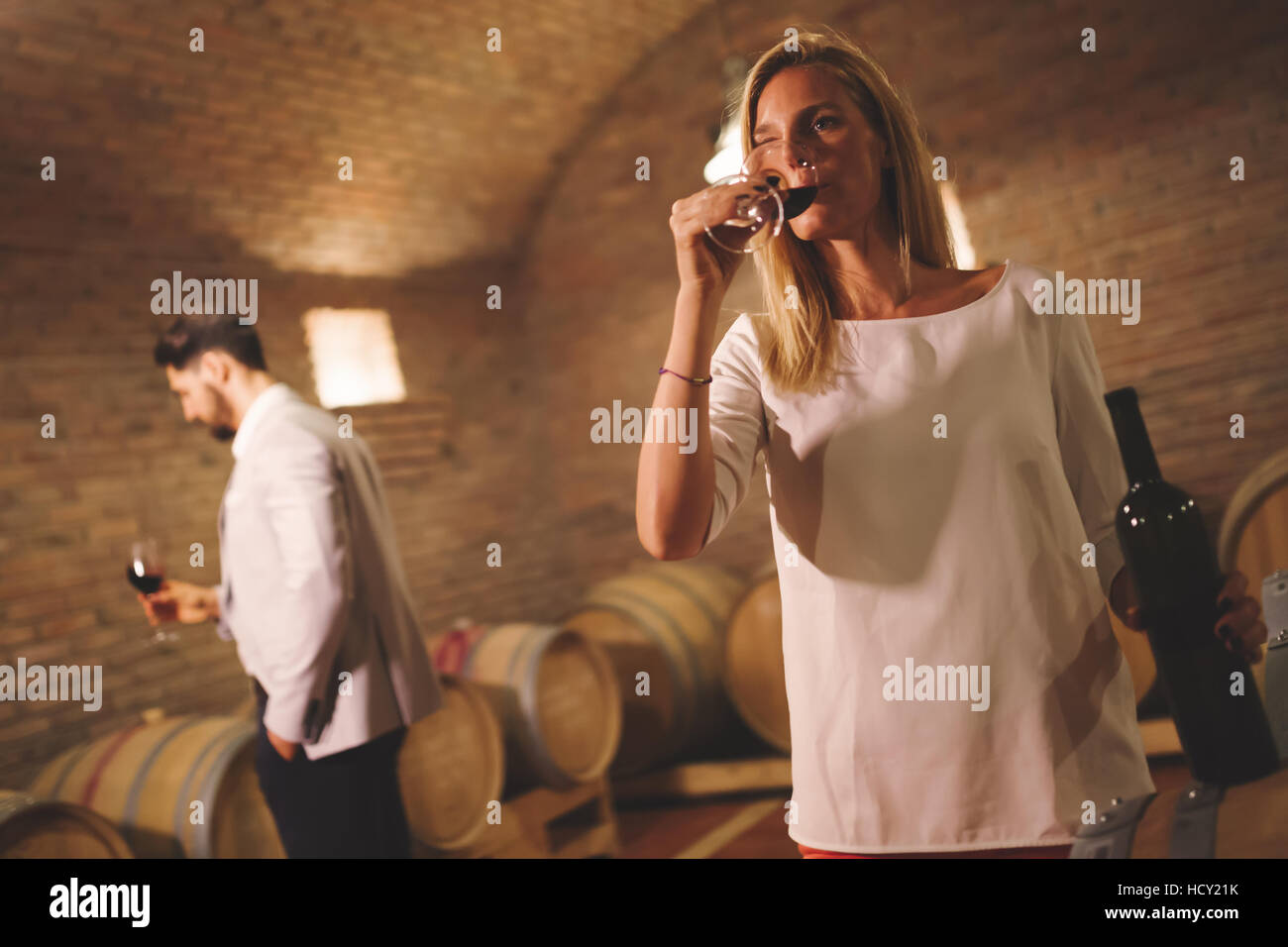 People tasting wine in winery basement Stock Photo - Alamy