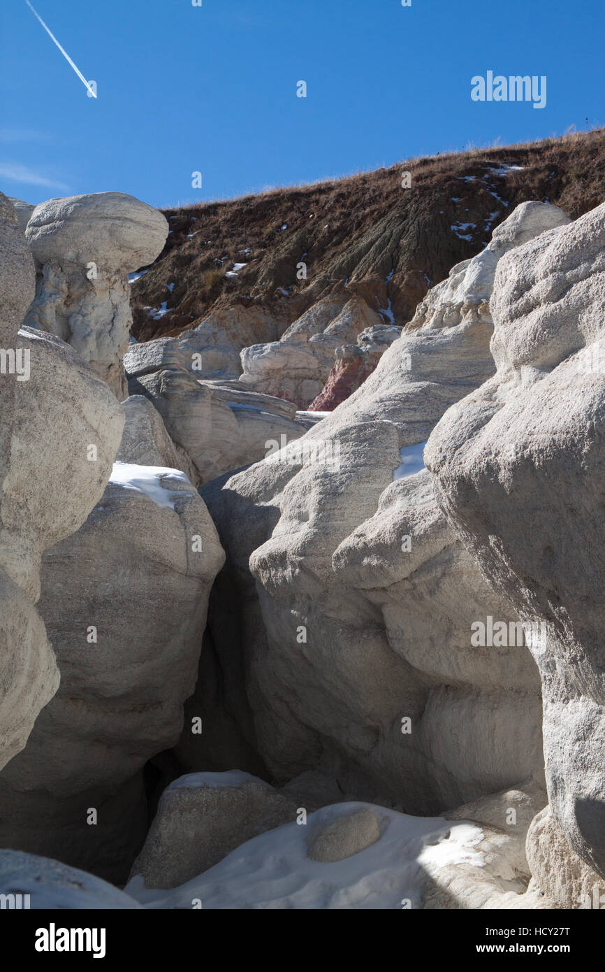 Hoodoos in Paint Mines Interpretive Park with a jet passing overhead ...