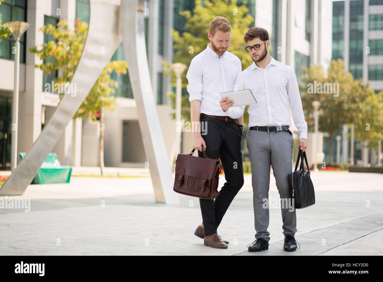 Busy business people using technology on street Stock Photo - Alamy