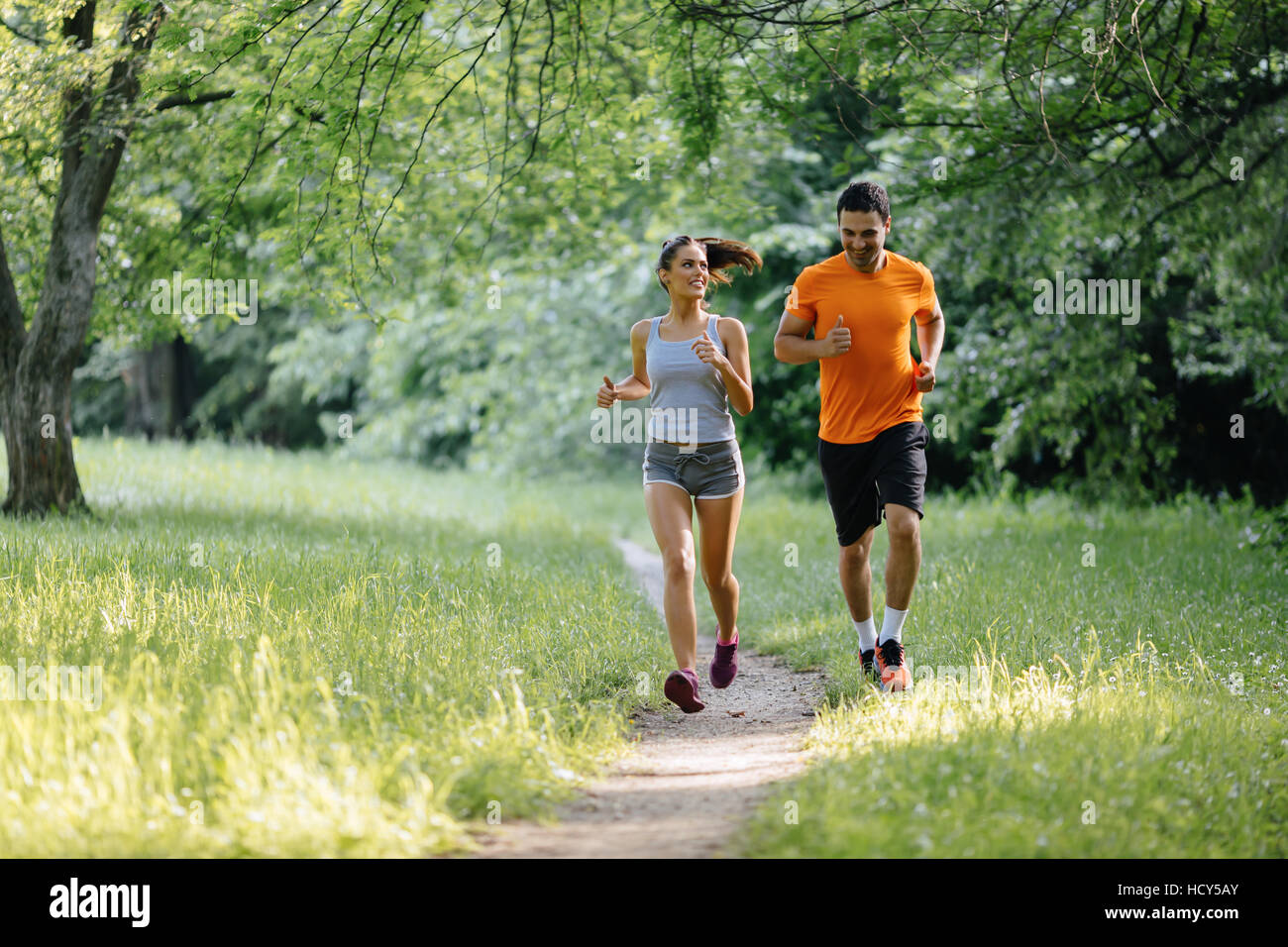 Couple jogging and running outdoors in nature Stock Photo - Alamy