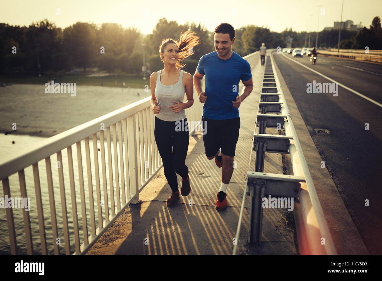Athletic couple jogging together outdoors Stock Photo - Alamy
