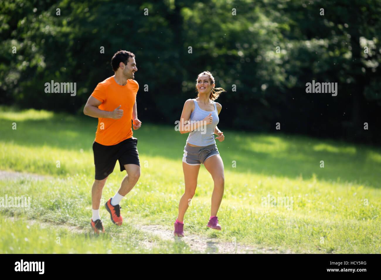 Couple jogging and running outdoors in nature Stock Photo - Alamy