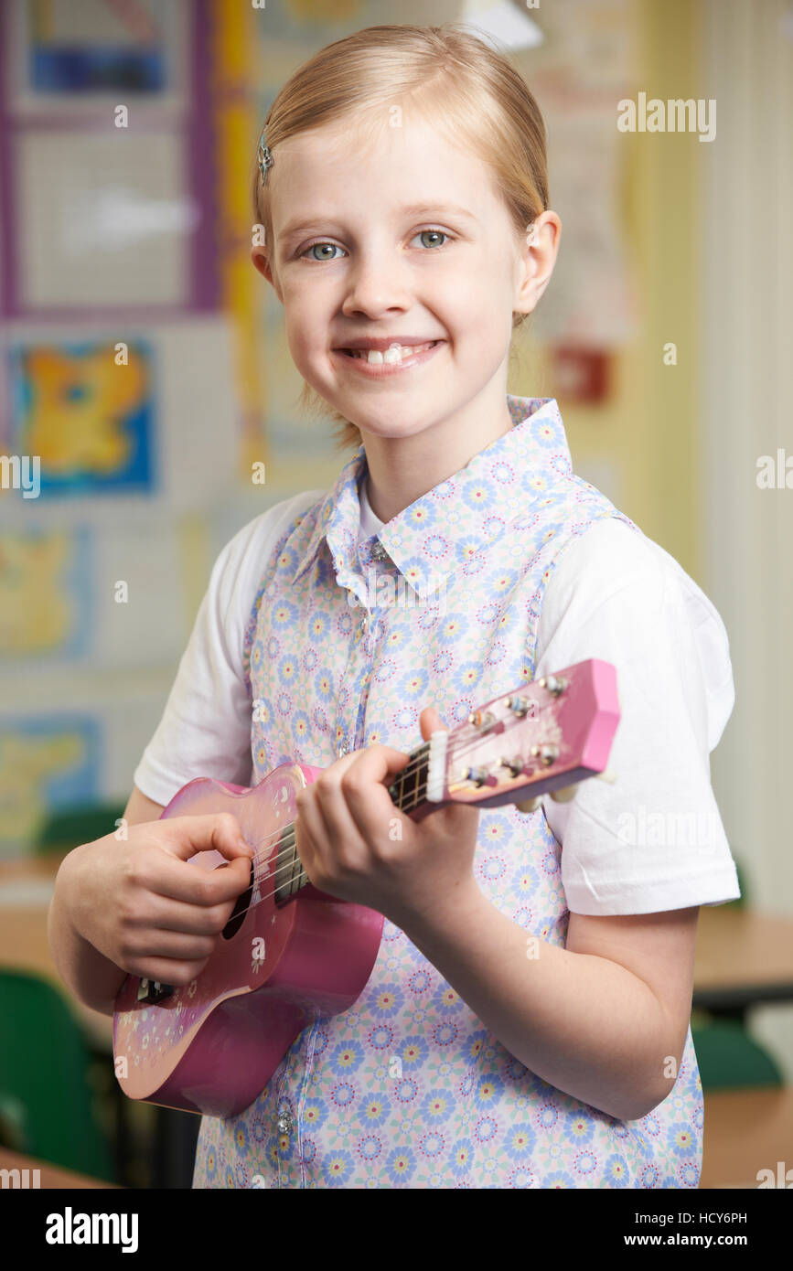 Girl Learning To Play Ukulele In School Music Lesson Stock Photo - Alamy