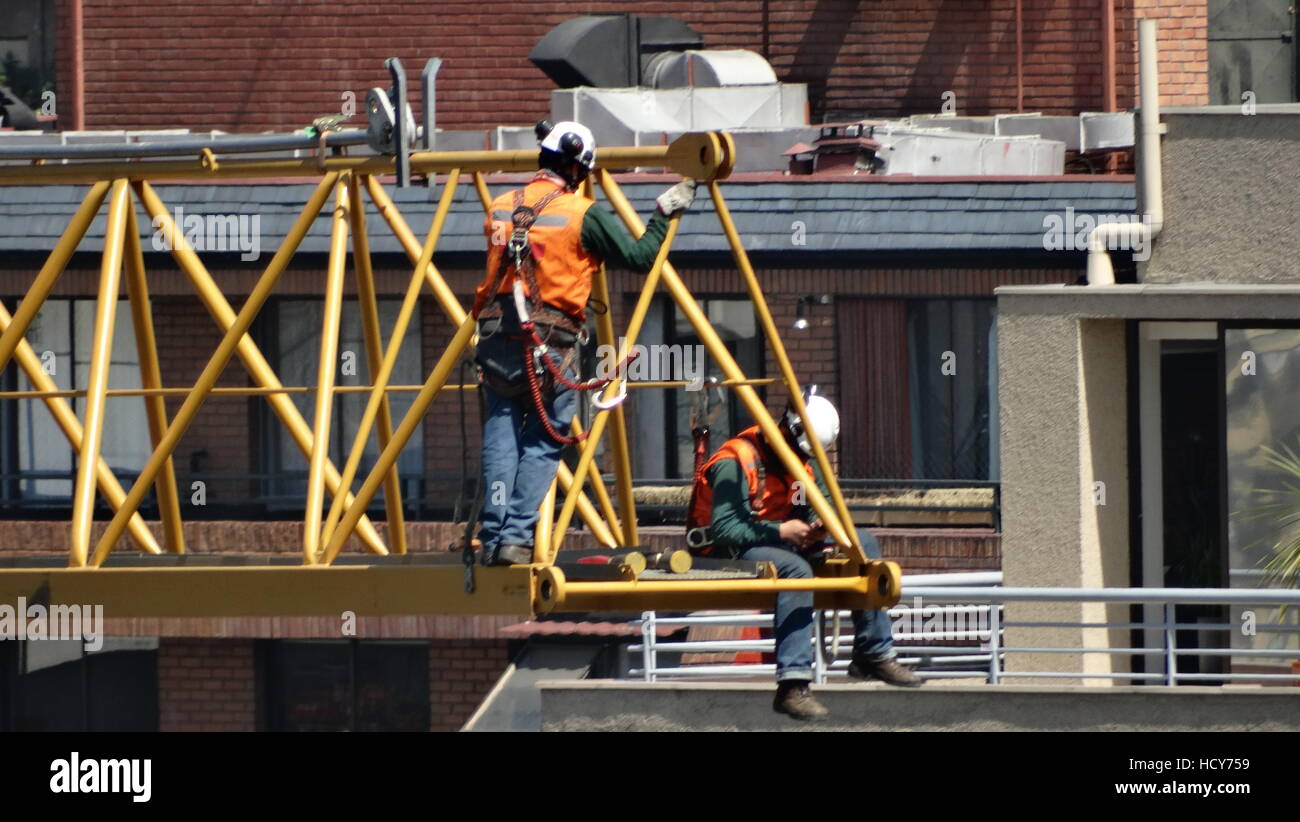 Engineer installing tower crane in Santiago Chile Stock Photo - Alamy