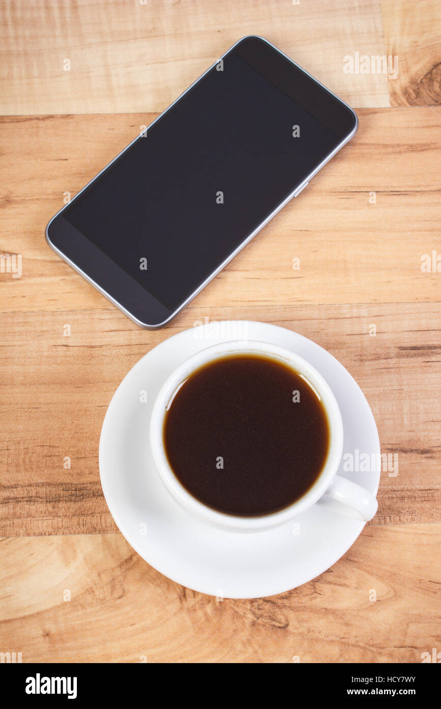 Mobile phone with blank screen, smartphone and relax with black coffee ...