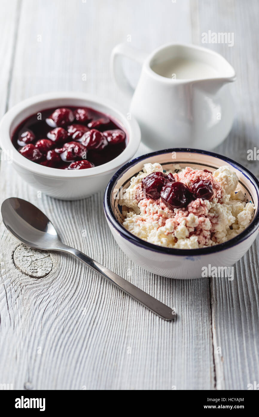 Breakfast from cottage cheese with cherry jam on a white wooden ...