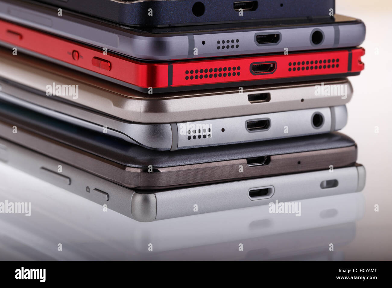 Pile of mobile phone. Heap of the different smartphones on white ...