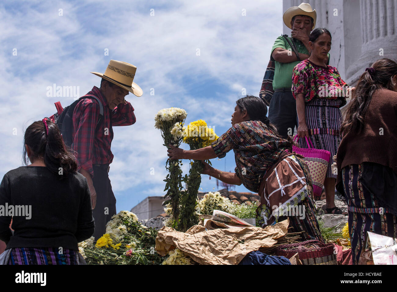 Quiche Mayan woman in traditional dress selling flowers on the steps of ...
