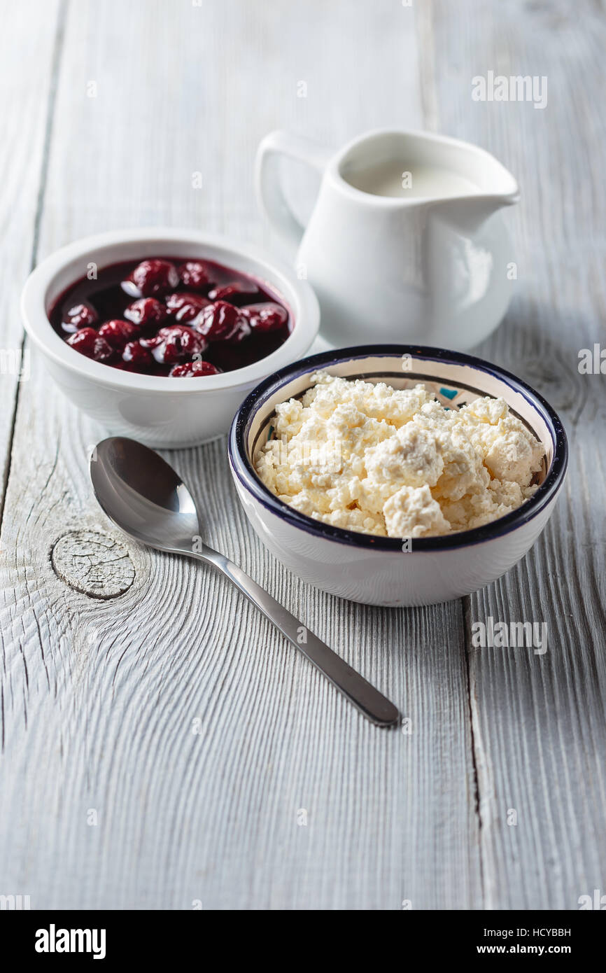 Breakfast from cottage cheese with cherry jam on a white wooden ...