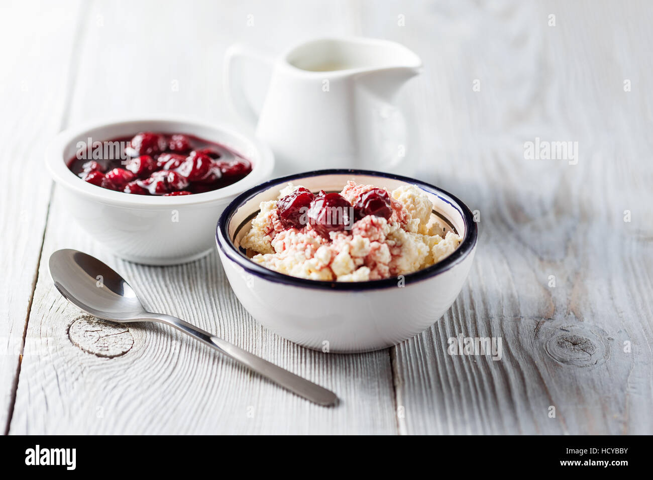 Breakfast from cottage cheese with cherry jam on a white wooden ...