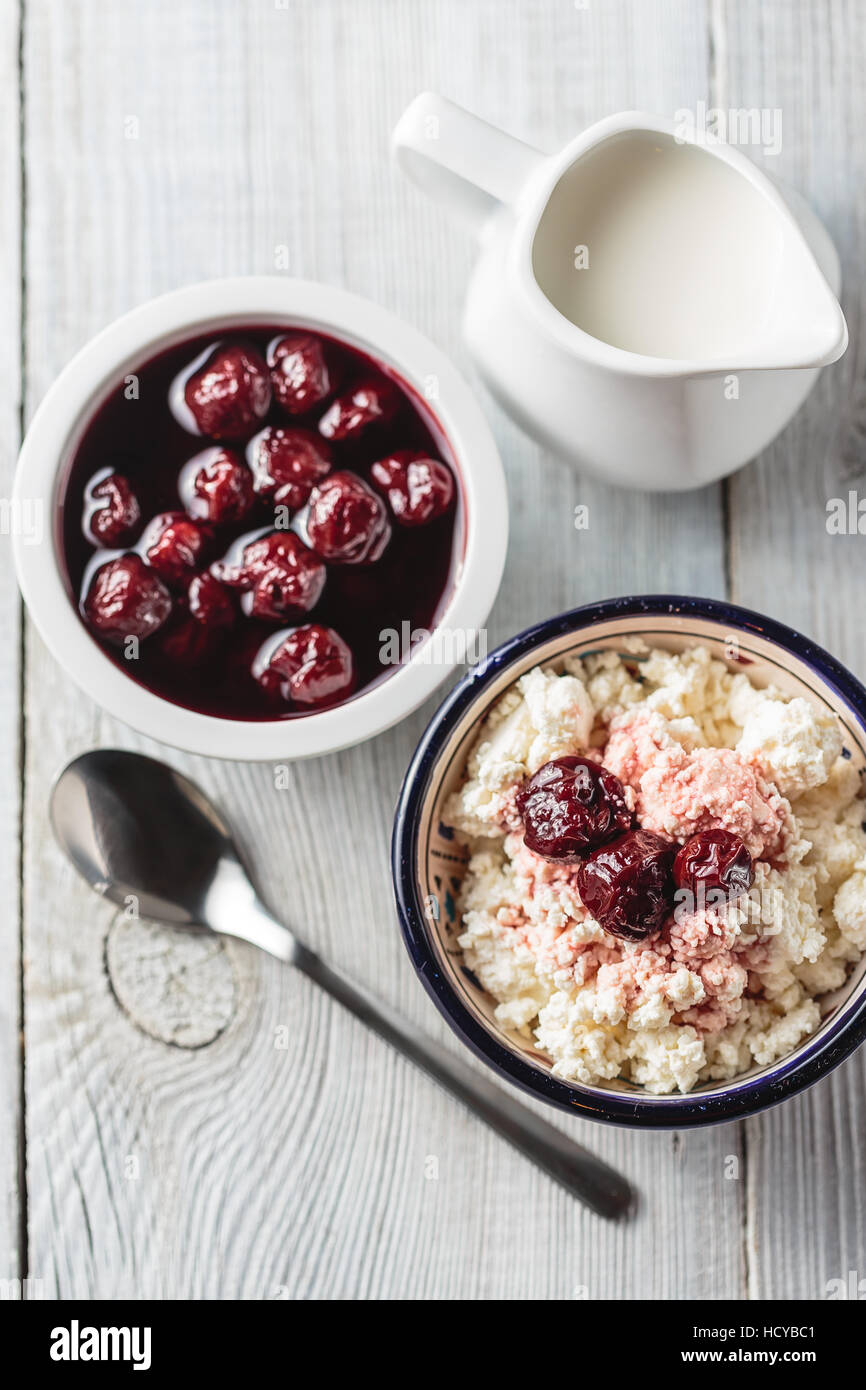 Breakfast from cottage cheese with cherry jam on a white wooden ...