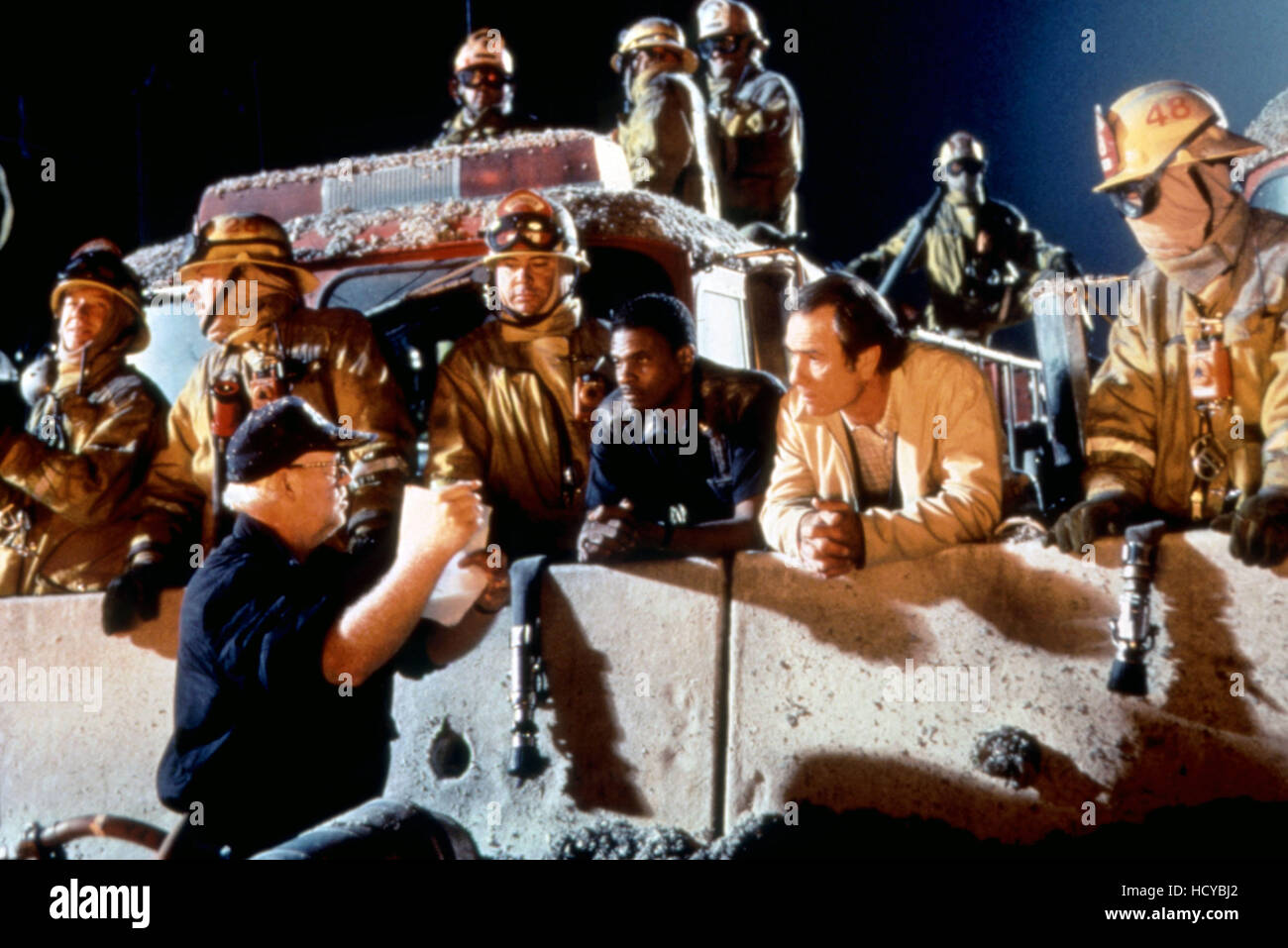 VOLCANO, director Mick Jackson (left, wearing baseball cap), Keith ...