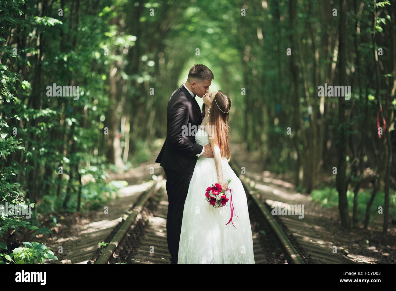 luxury stylish young bride and groom on the background spring sunny ...