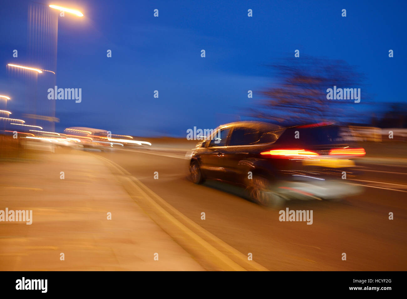 Blurred traffic on an urban road at dusk Stock Photo - Alamy