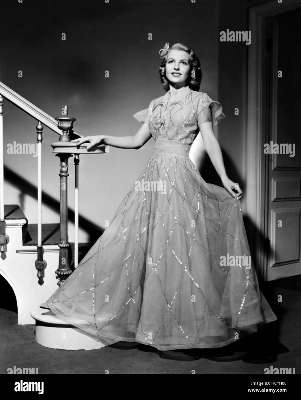 Betty Field, modeling a gray organza dancing frock with sequin trim by ...