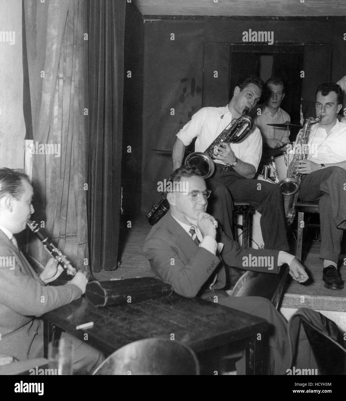 Benny Goodman, (center) at the Rose Rouge in Paris, listening to jazz ...