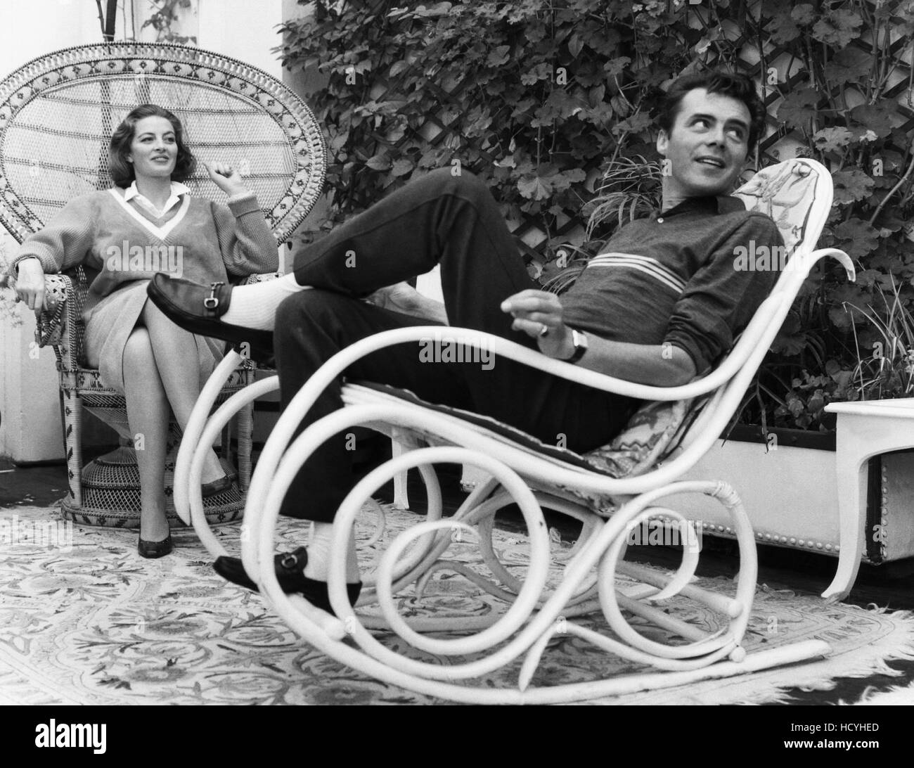 From left, Capucine, Dirk Bogarde, relaxing at Bogarde's home during ...