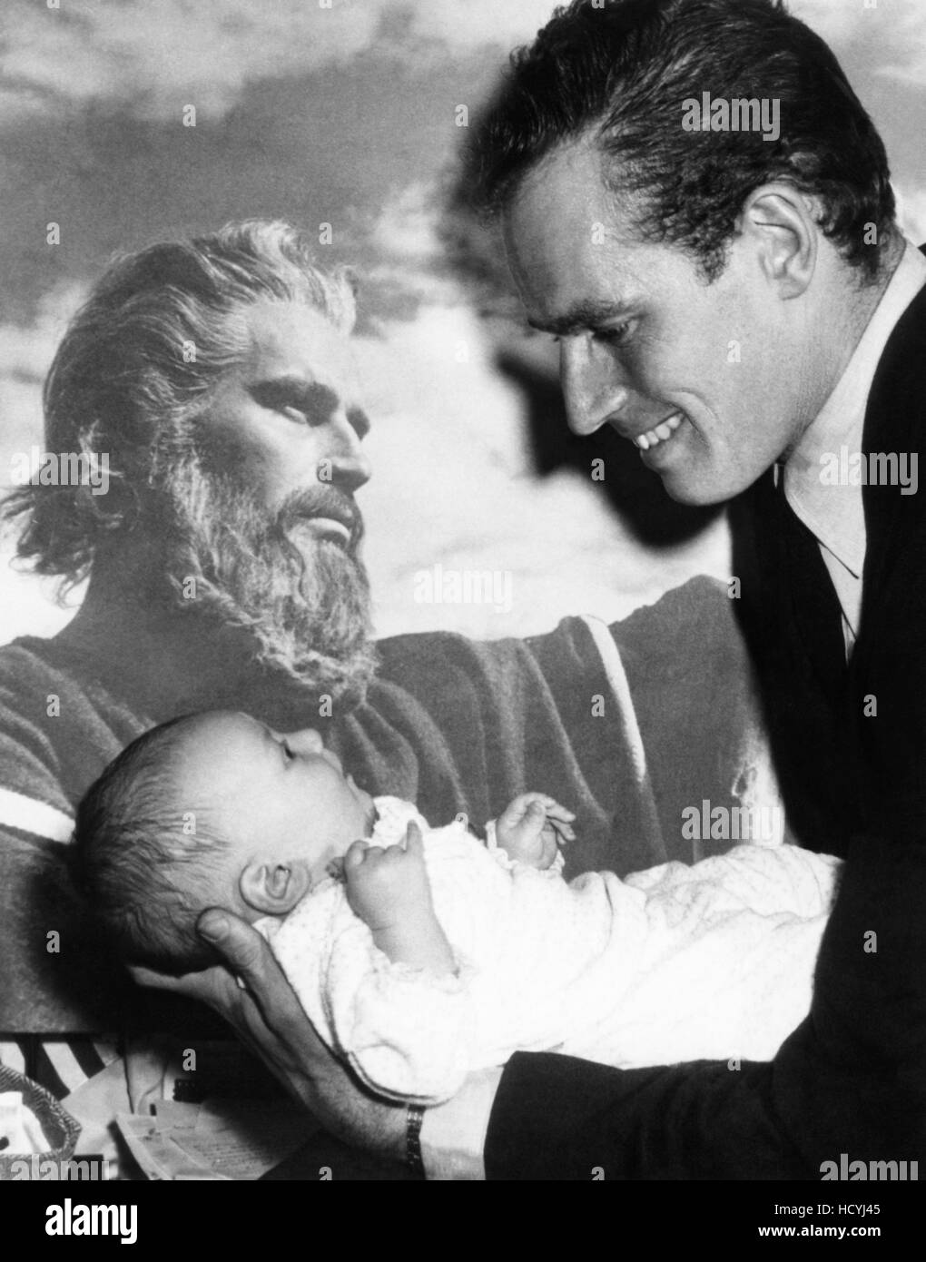 Charlton Heston holding his infant son Fraser Heston in front of a ...