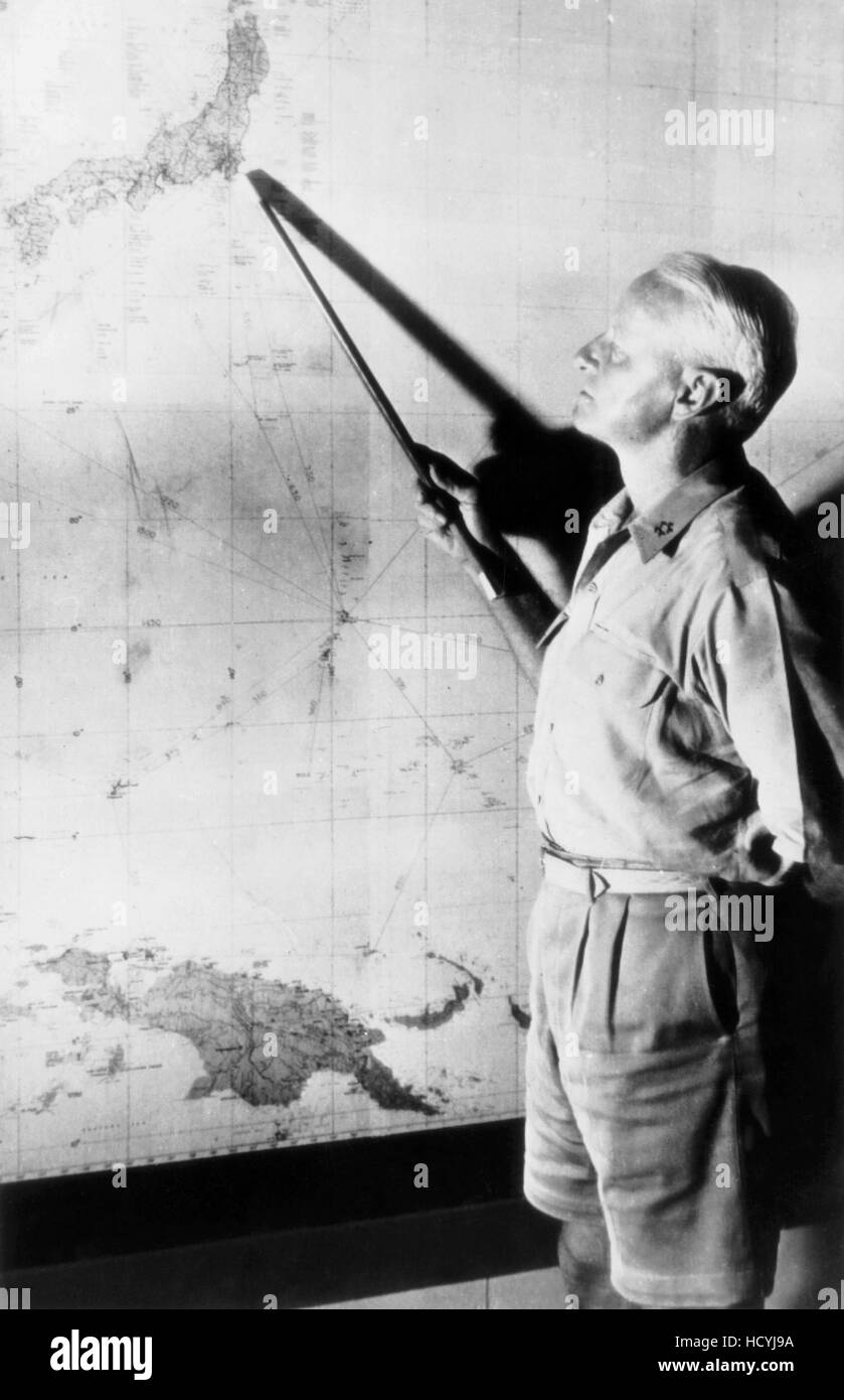 Fleet Admiral Chester Nimitz, in Guam, pointing out Tokyo on a war map ...