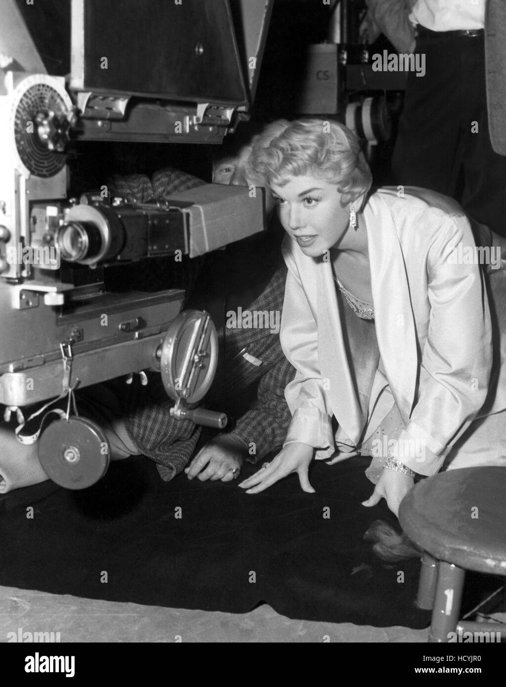 DORIS DAY peeks through the CinemaScope camera during production of ...