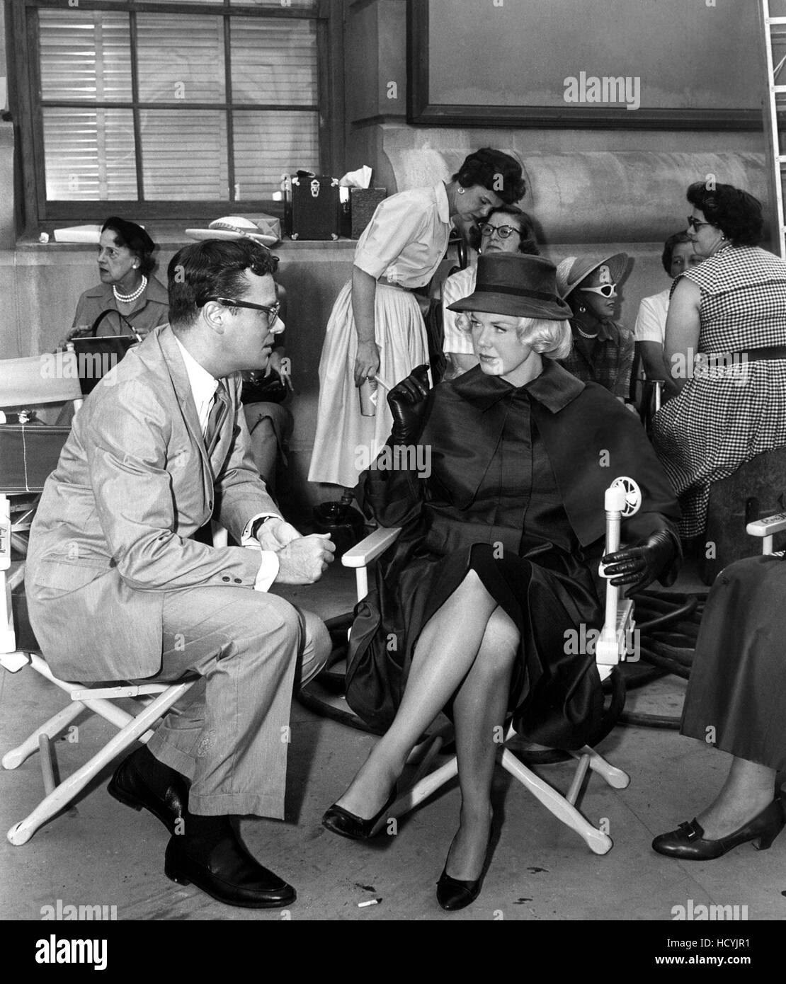 Producer ROSS HUNTER confers with star DORIS DAY during production of ...