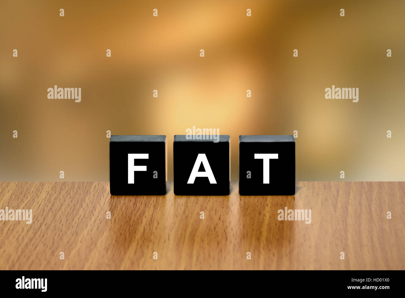 Fat on black block with blurred background Stock Photo - Alamy