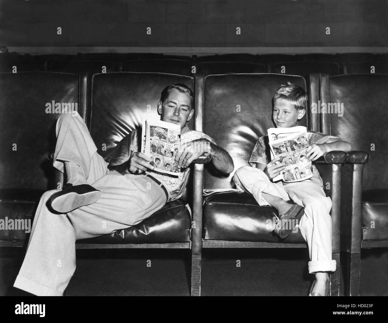 ALAN LADD, with son David reading comic books together Stock Photo - Alamy