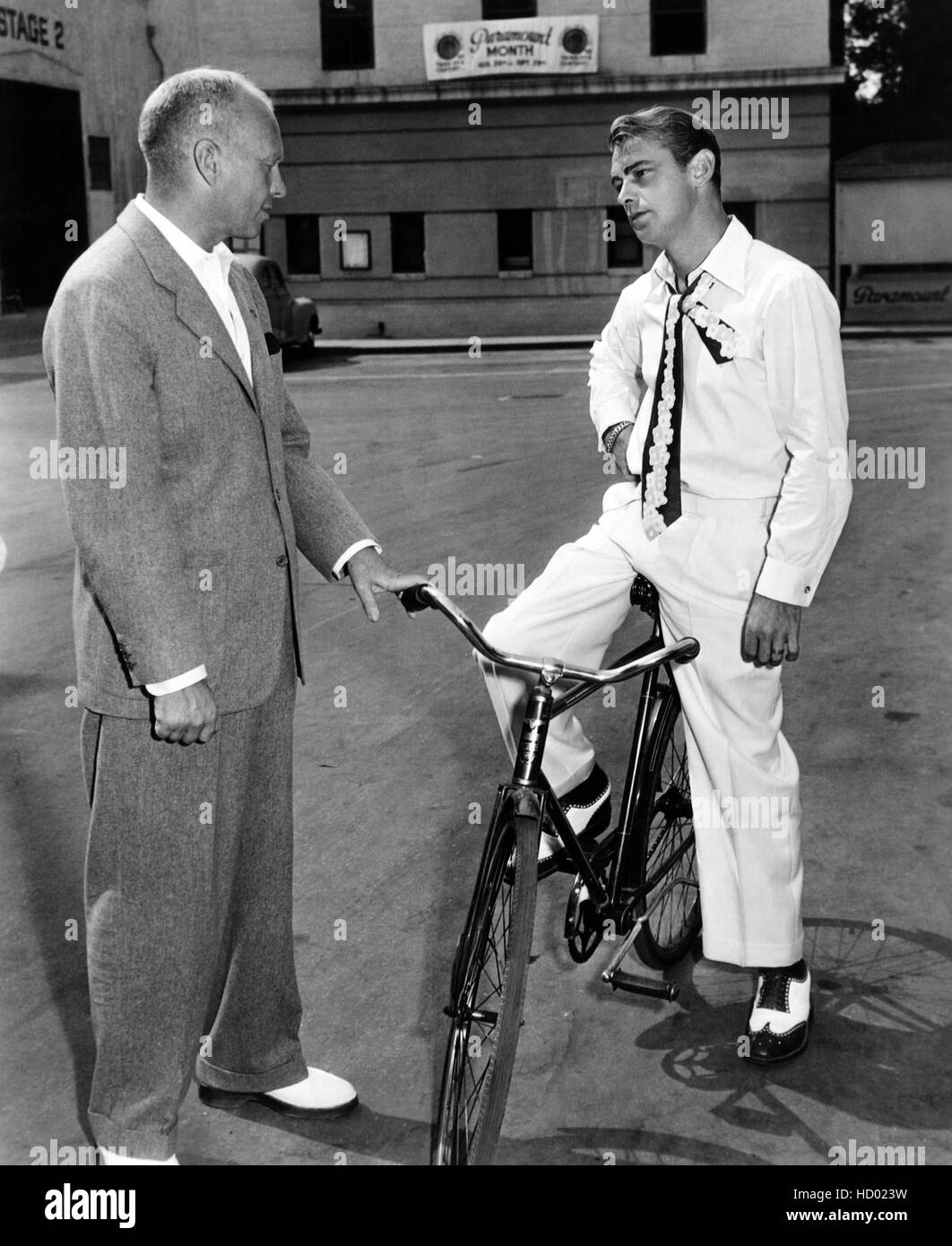 John Farrow, Alan Ladd, on Paramount back lot, summer 1946 Stock Photo ...