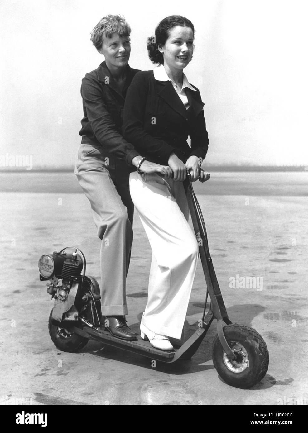 Amelia Earhart, left, and June Travis, trying out an electric scooter ...