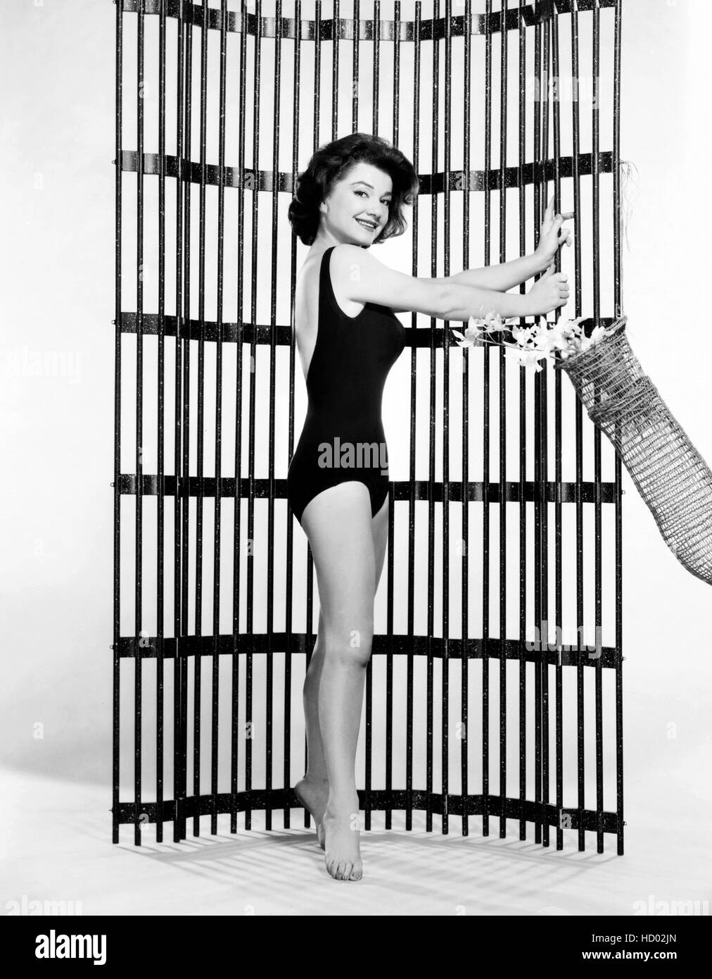 Anne Baxter, caught in a candid moment on tip-toes in her bathing suit ...