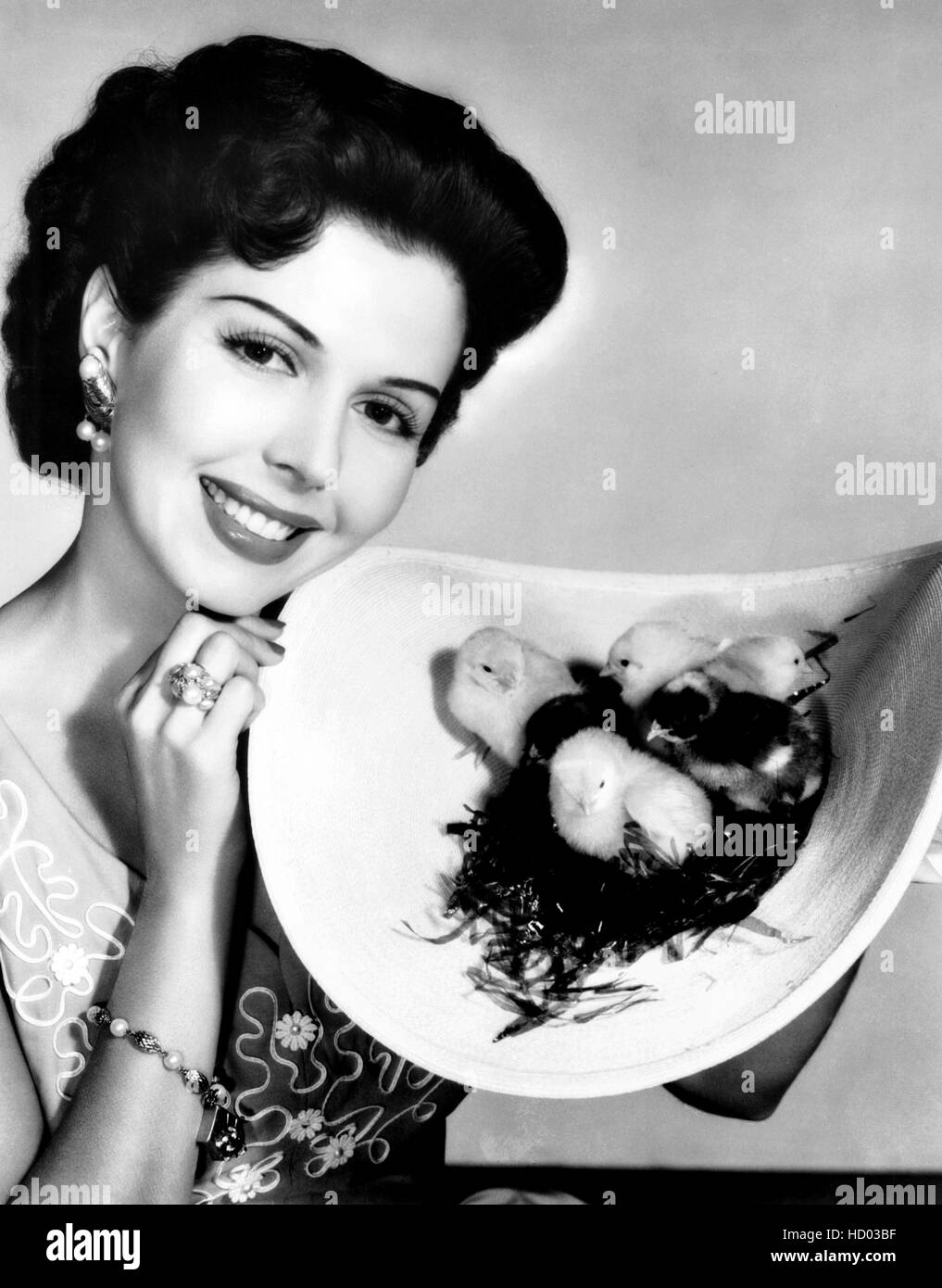Ann Miller, with an Easter bonnet full of chicks, ca. 1950 Stock Photo ...