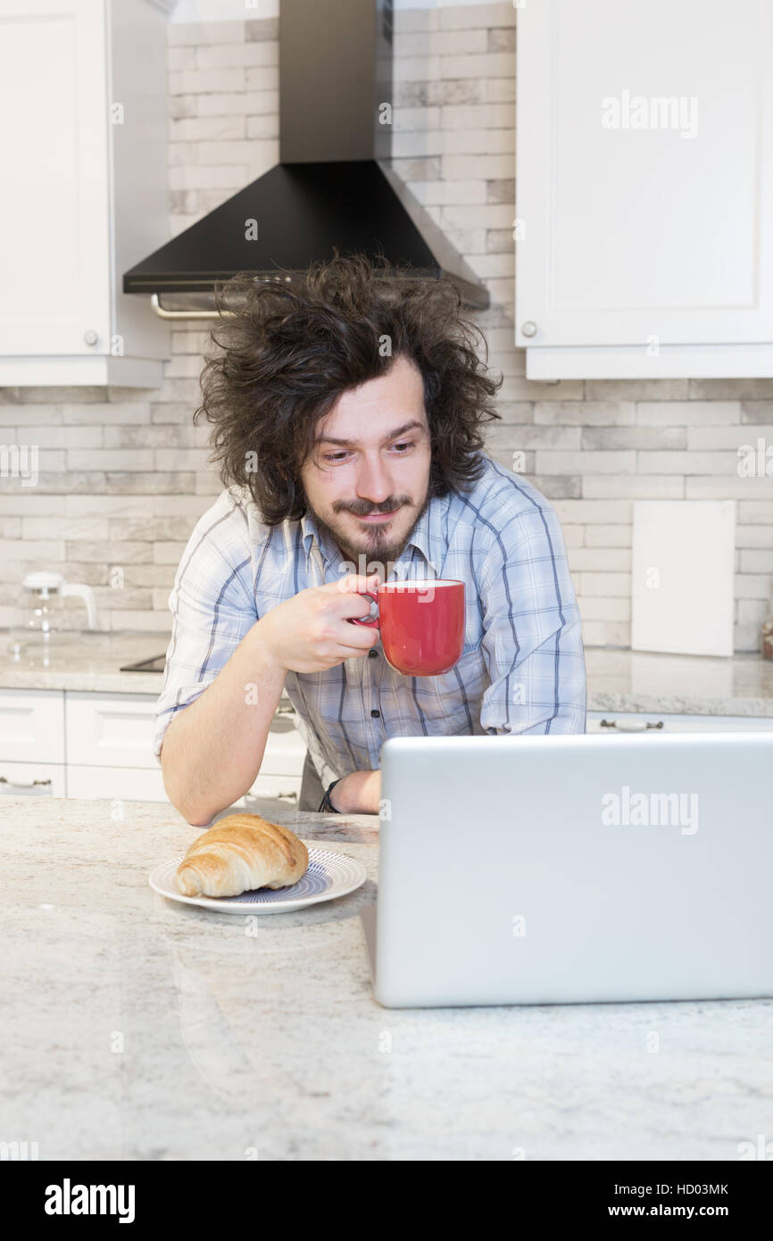 Man Eating Breakfast Using Laptop, Man in kitchen drinking coffe Stock ...