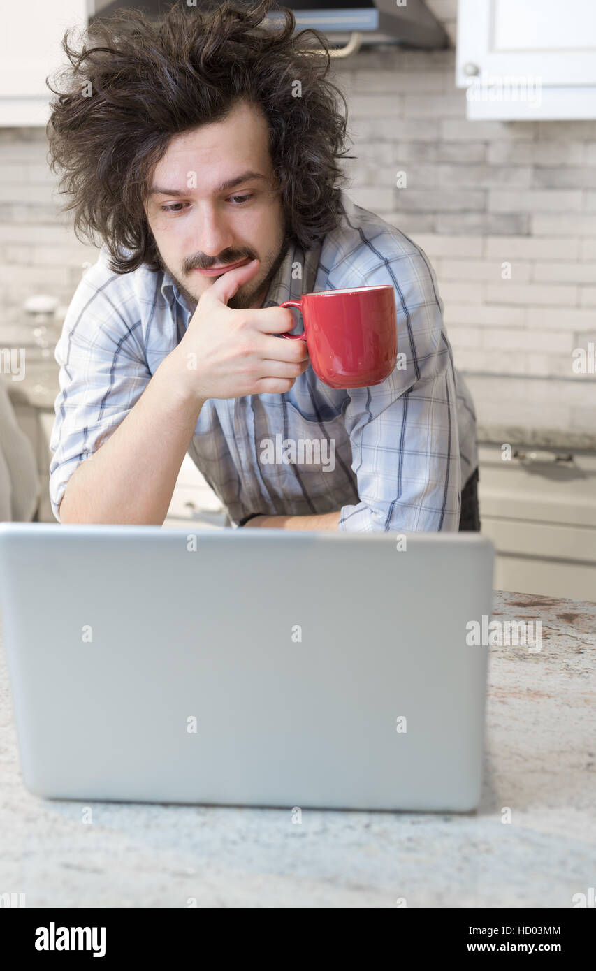 Man Eating Breakfast Using Laptop, Man in kitchen drinking coffe Stock ...