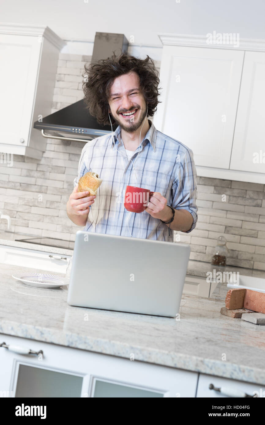 Man Eating Breakfast Using Laptop, Man in kitchen drinking coffe Stock ...