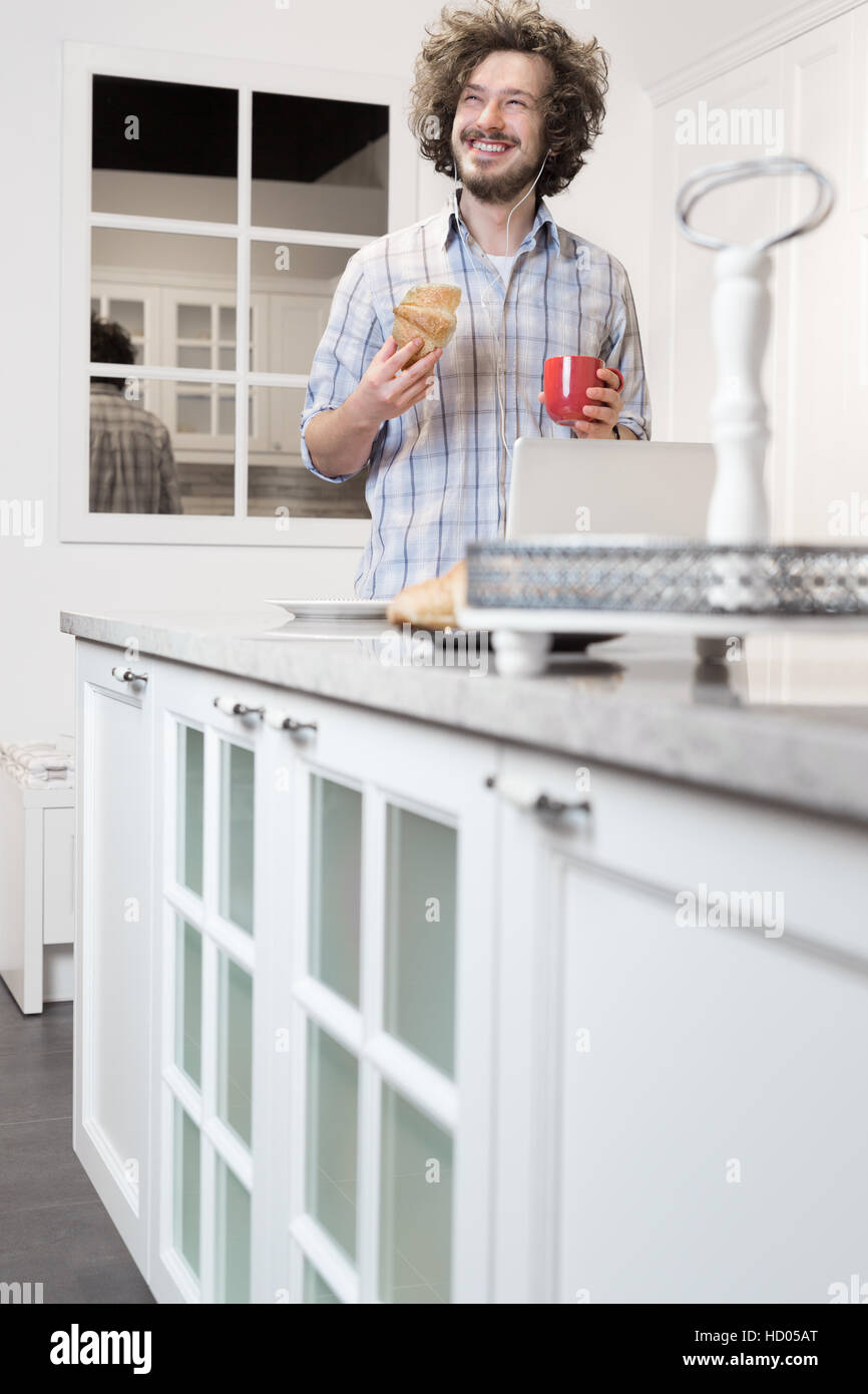 Man Eating Breakfast Using Laptop, Man in kitchen drinking coffe Stock ...