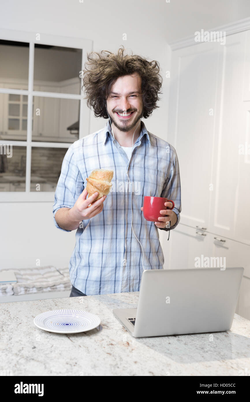Man Eating Breakfast Using Laptop, Man in kitchen drinking coffe Stock ...