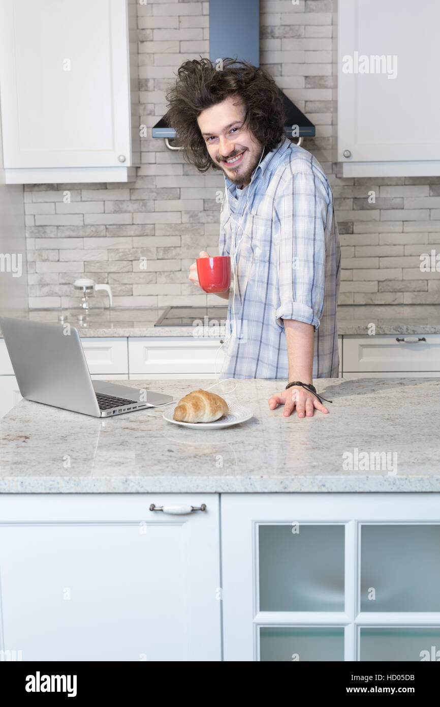 Man Eating Breakfast Using Laptop, Man in kitchen drinking coffe Stock ...